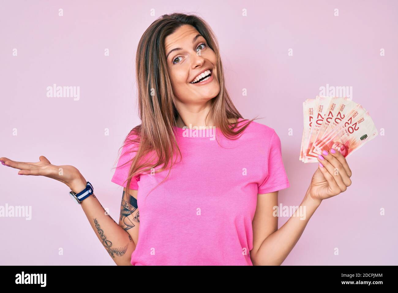 Beautiful caucasian woman holding israel shekels celebrating ...