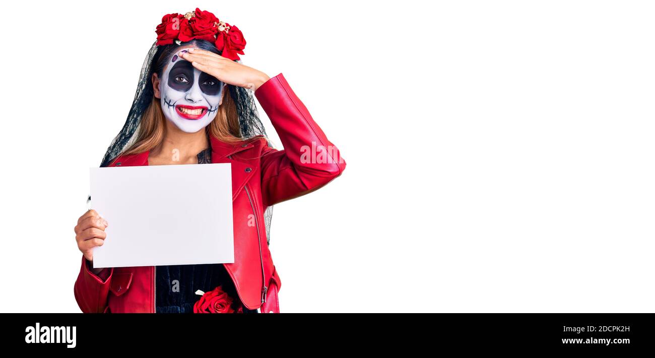 Woman wearing day of the dead costume holding blank empty banner ...