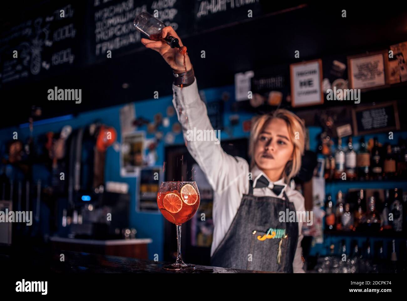 Girl bartender creates a cocktail in the saloon Stock Photo - Alamy