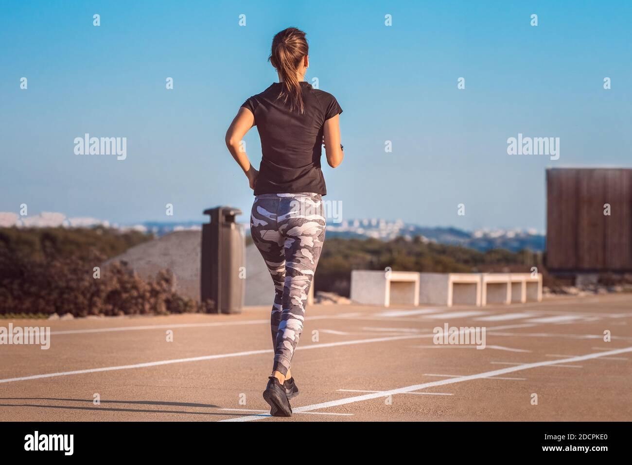 Young fitness woman runner athlete running on the road. Fitness and ...