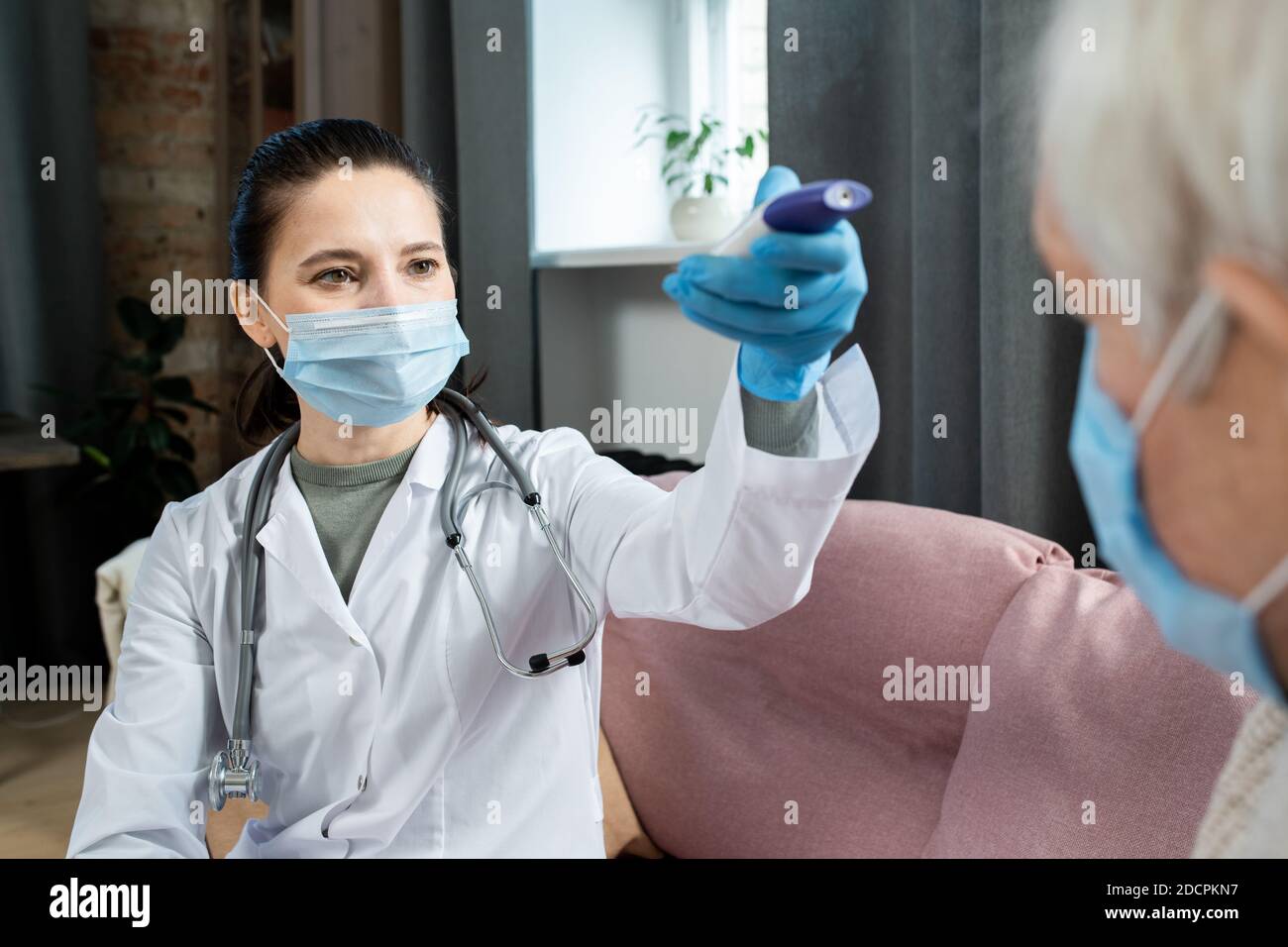 Contactless thermometer with doctor hi-res stock photography and images ...