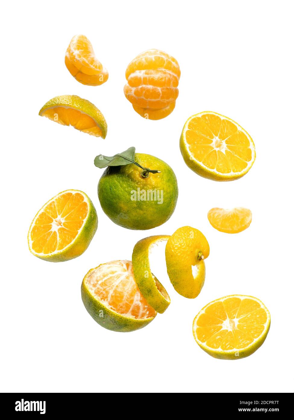 Fresh ripe green mandarine with leaf falling in air. Cut, peeled ...