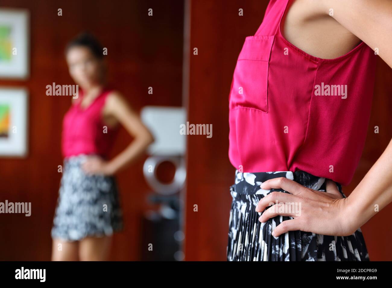 Woman getting ready in the morning trying on clothing choosing what to ...