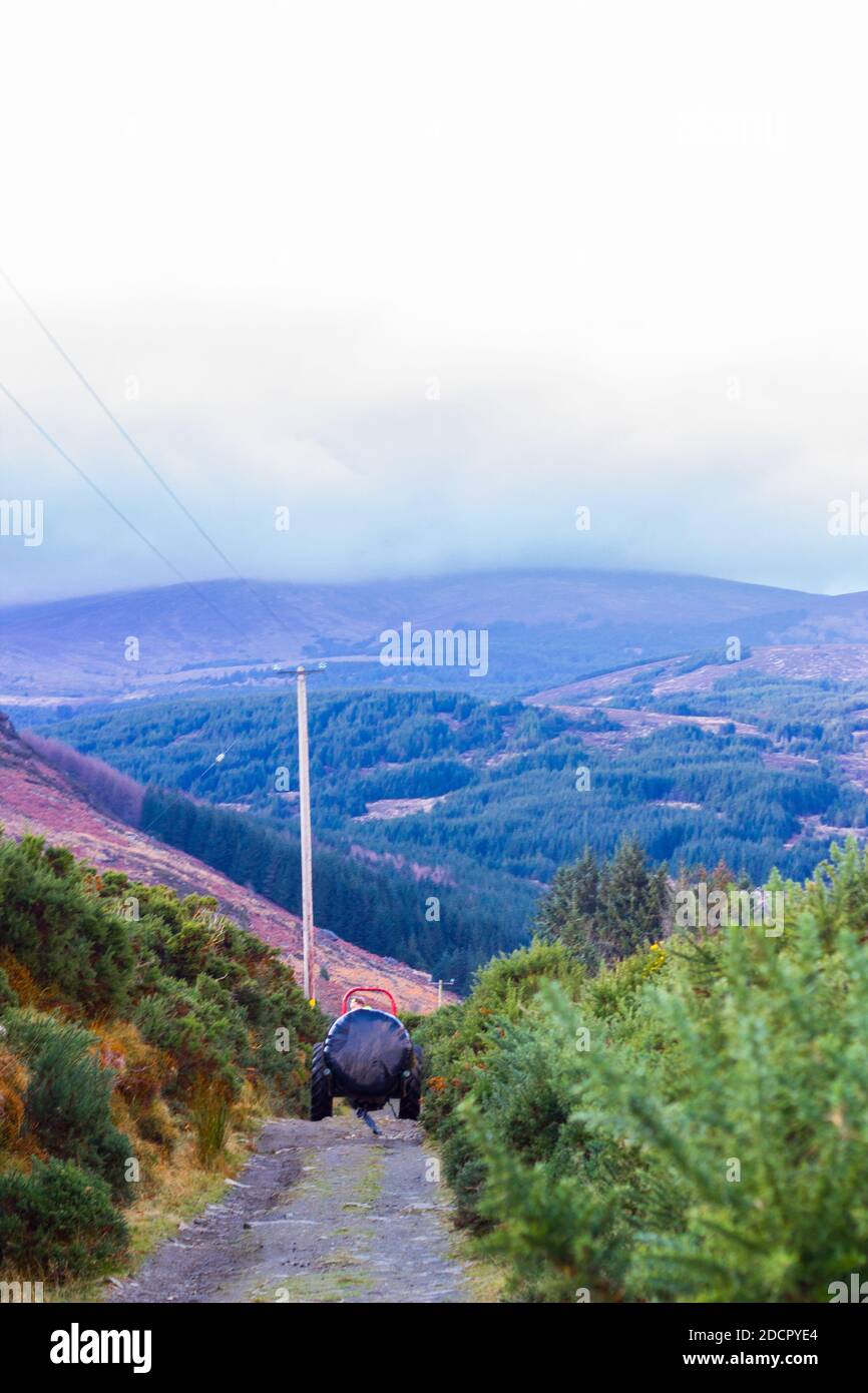 Country road with farmer on his tractor in Co.Wicklow, Ireland Stock ...
