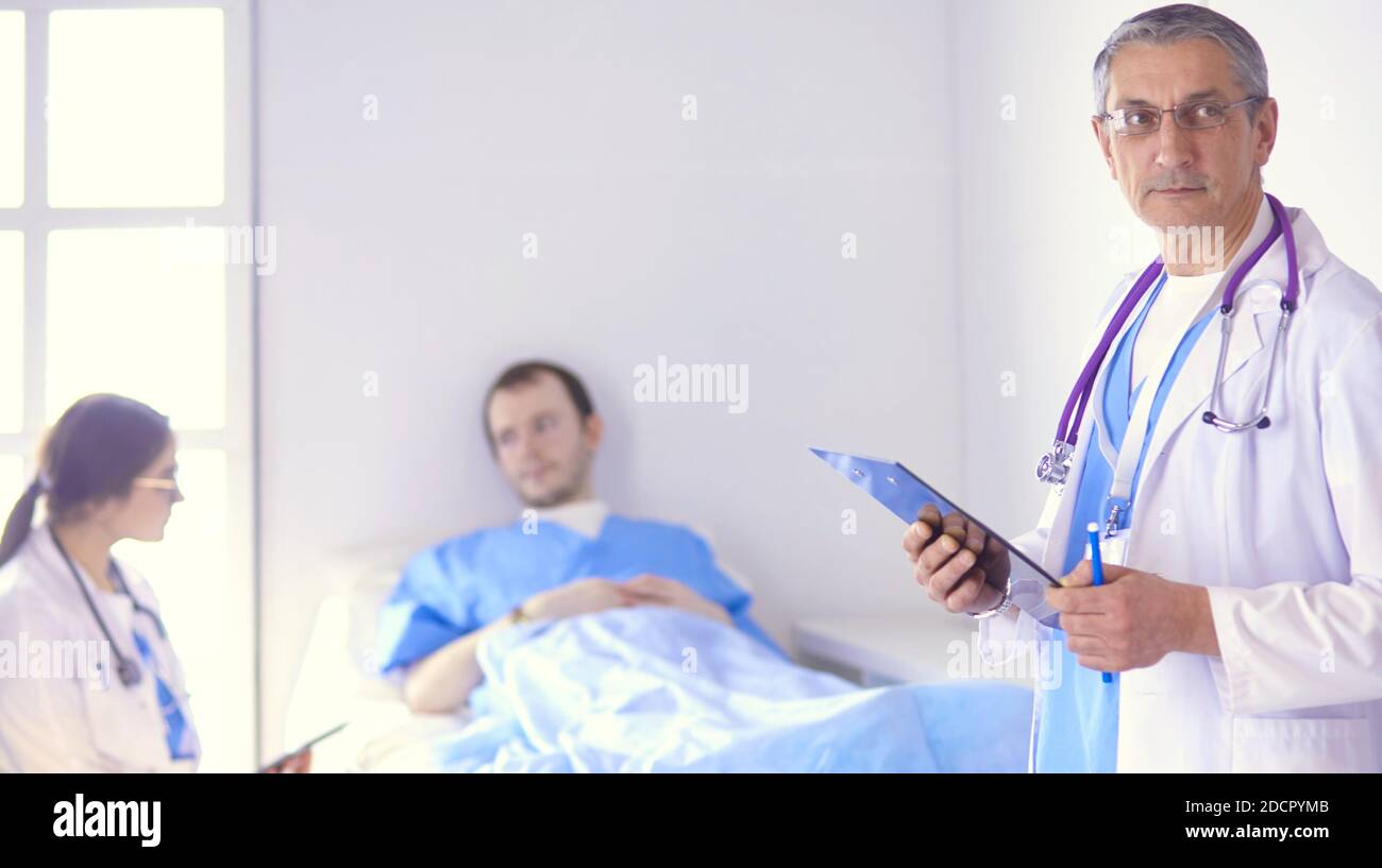 Doctor checking heart beat of patient in bed with stethoscope Stock ...