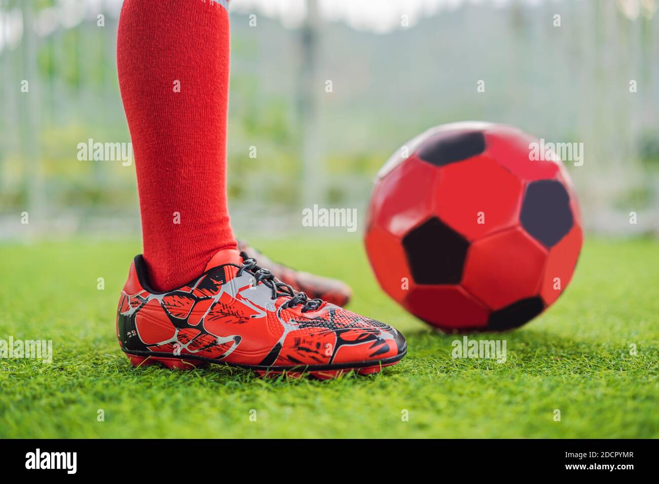 Little cute kid boy in red football uniform playing soccer, football on ...