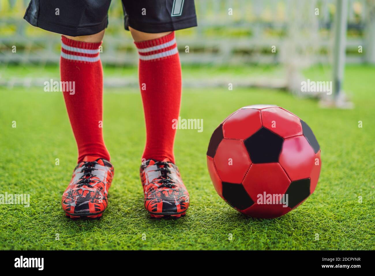 Little cute kid boy in red football uniform playing soccer, football on ...