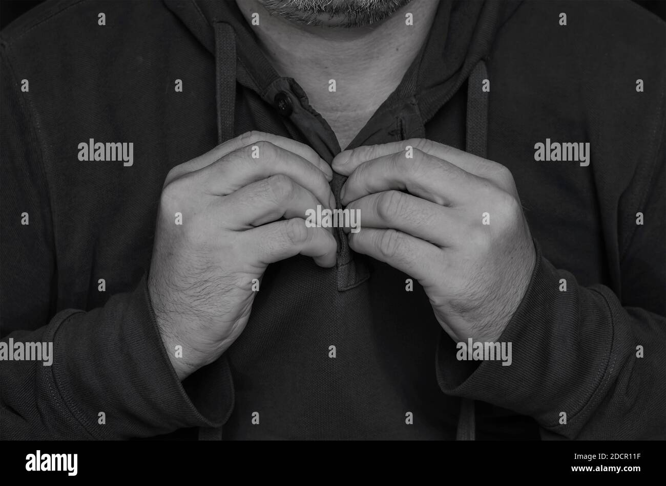 Man unbuttoned on sports sweater. Middle-aged man's hands on cardigan ...