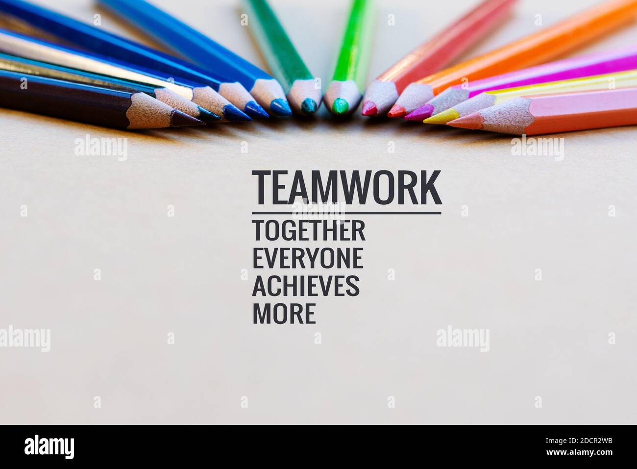 Teamwork concept. group of color pencil on brown background with word ...