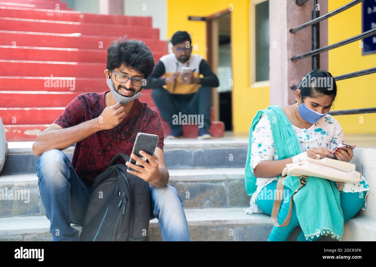 college students busy using mobile with face mask - happy millennial ...