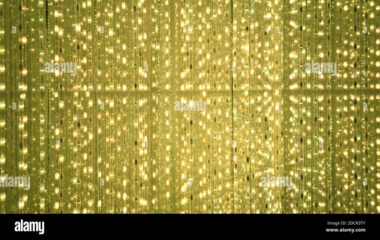 Golden background of LED flashing, blinking and flickering bulbs. Disco ...