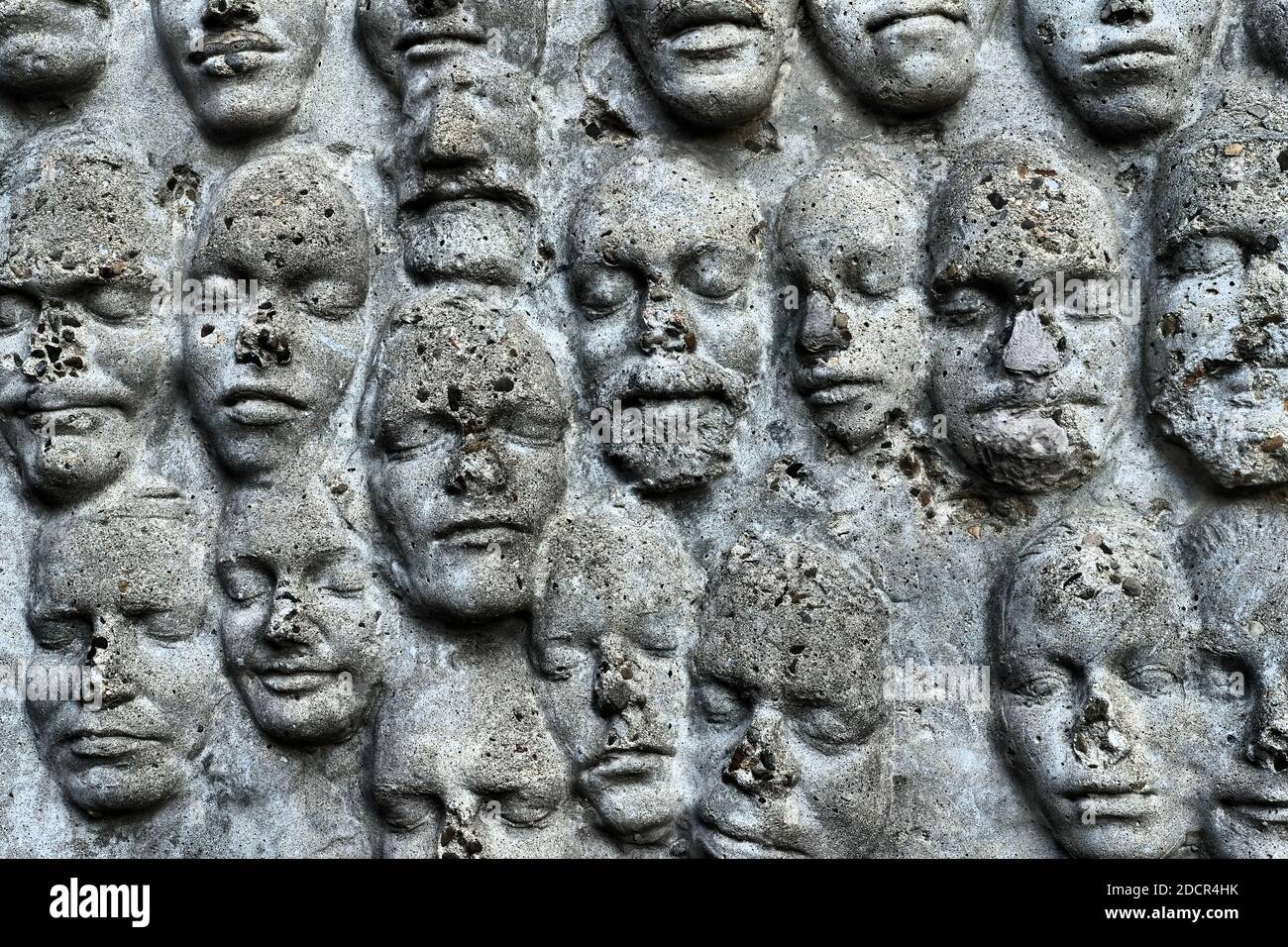 Faces cast in cement on a weathered wall at the City College of San ...