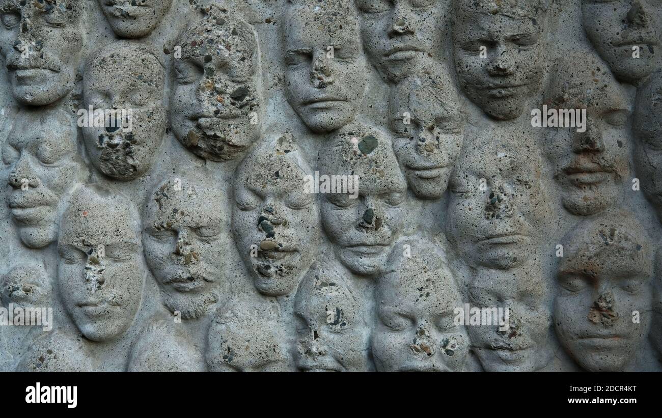 Faces cast in cement on a weathered wall at the City College of San ...