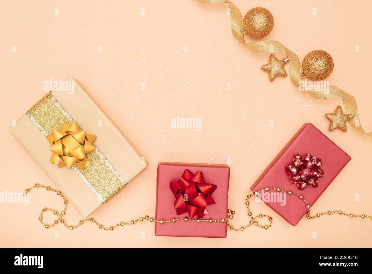 gifts boxes or presents boxes with red and golden bows, star and ball ...