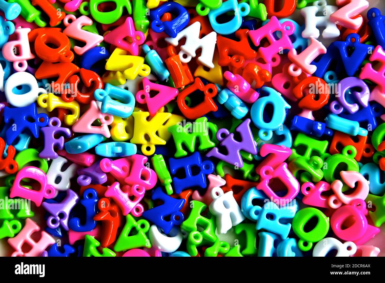 An aerial view of hundreds of colourful plastic alphabet beads Stock ...