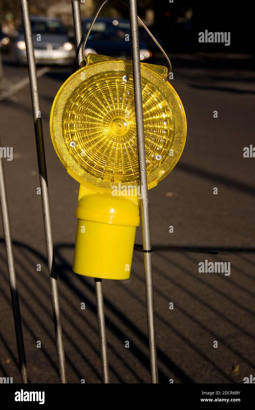 View of a Yellow lantern, road safety signs,, hanging from the barrier ...