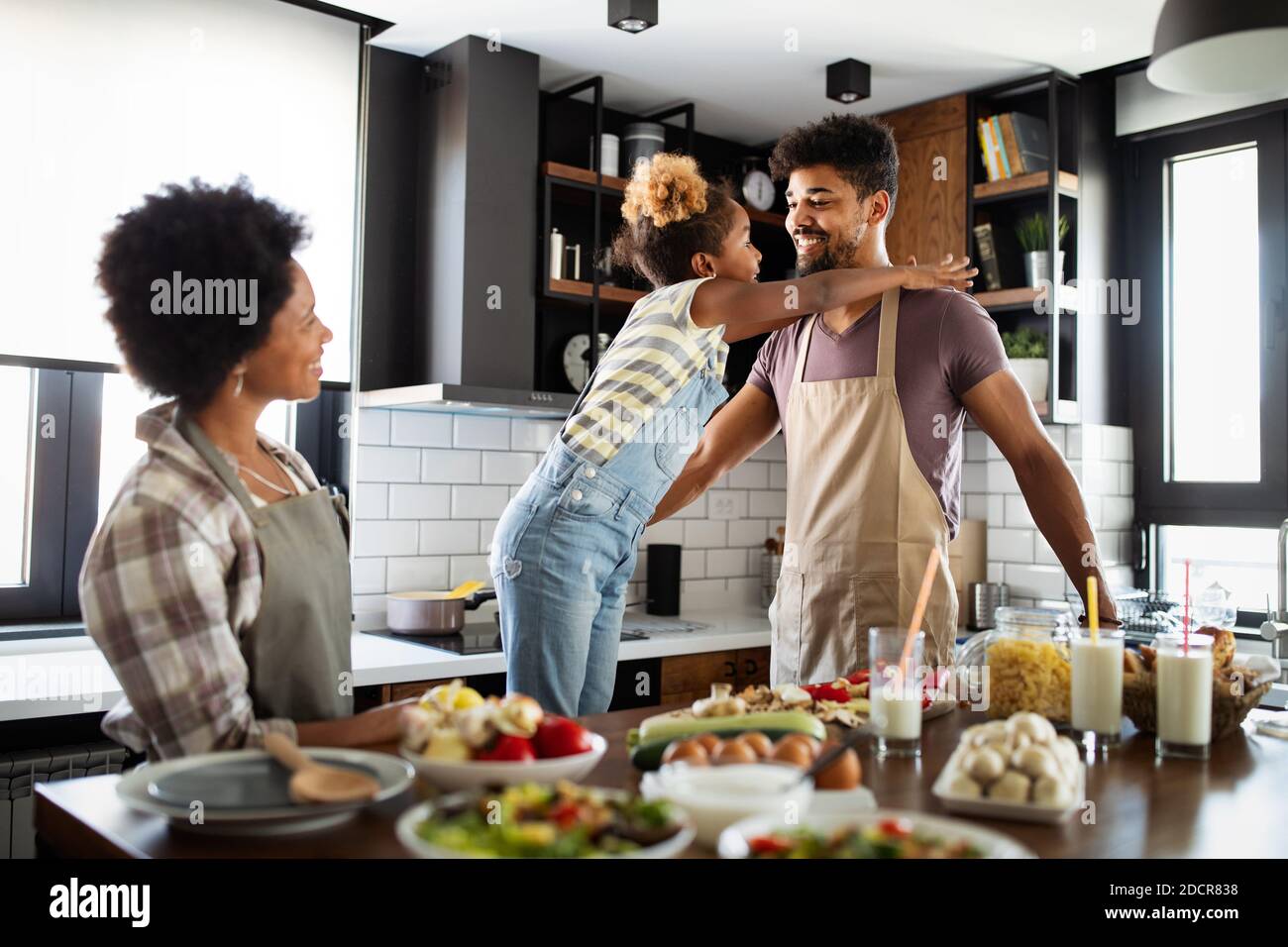 Happy family in the kitchen having fun and cooking together. Healthy ...