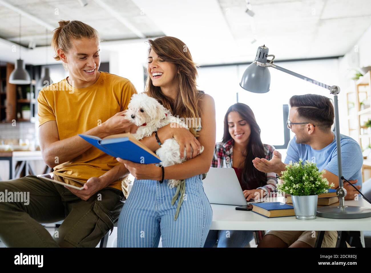 Multiracial young people enjoying group study at table Stock Photo - Alamy
