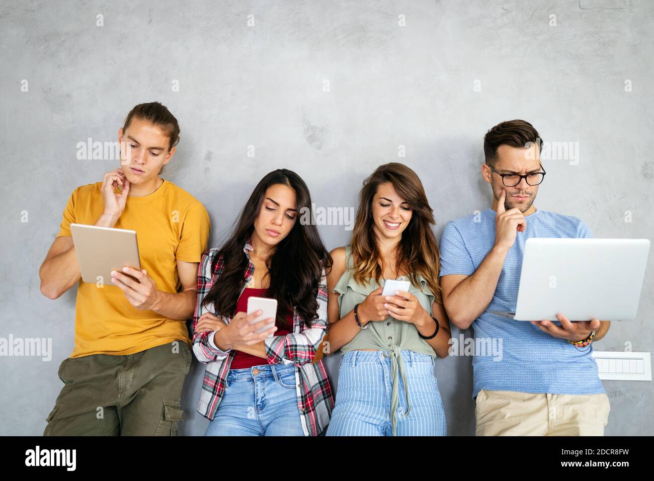 Happy young people working, using digital devices. Technology, people ...