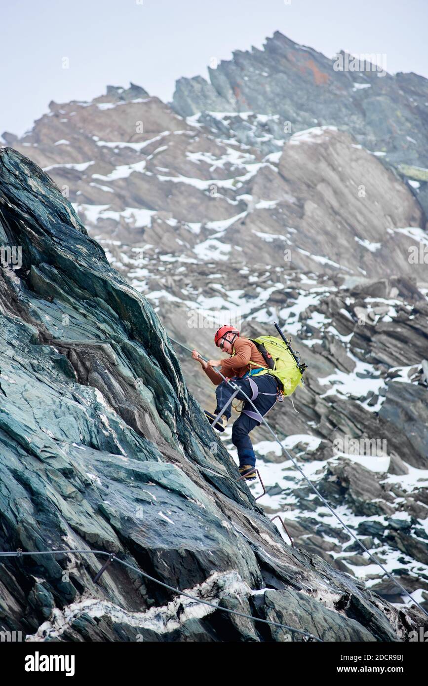 Side view of man climbing wall hi-res stock photography and images - Alamy