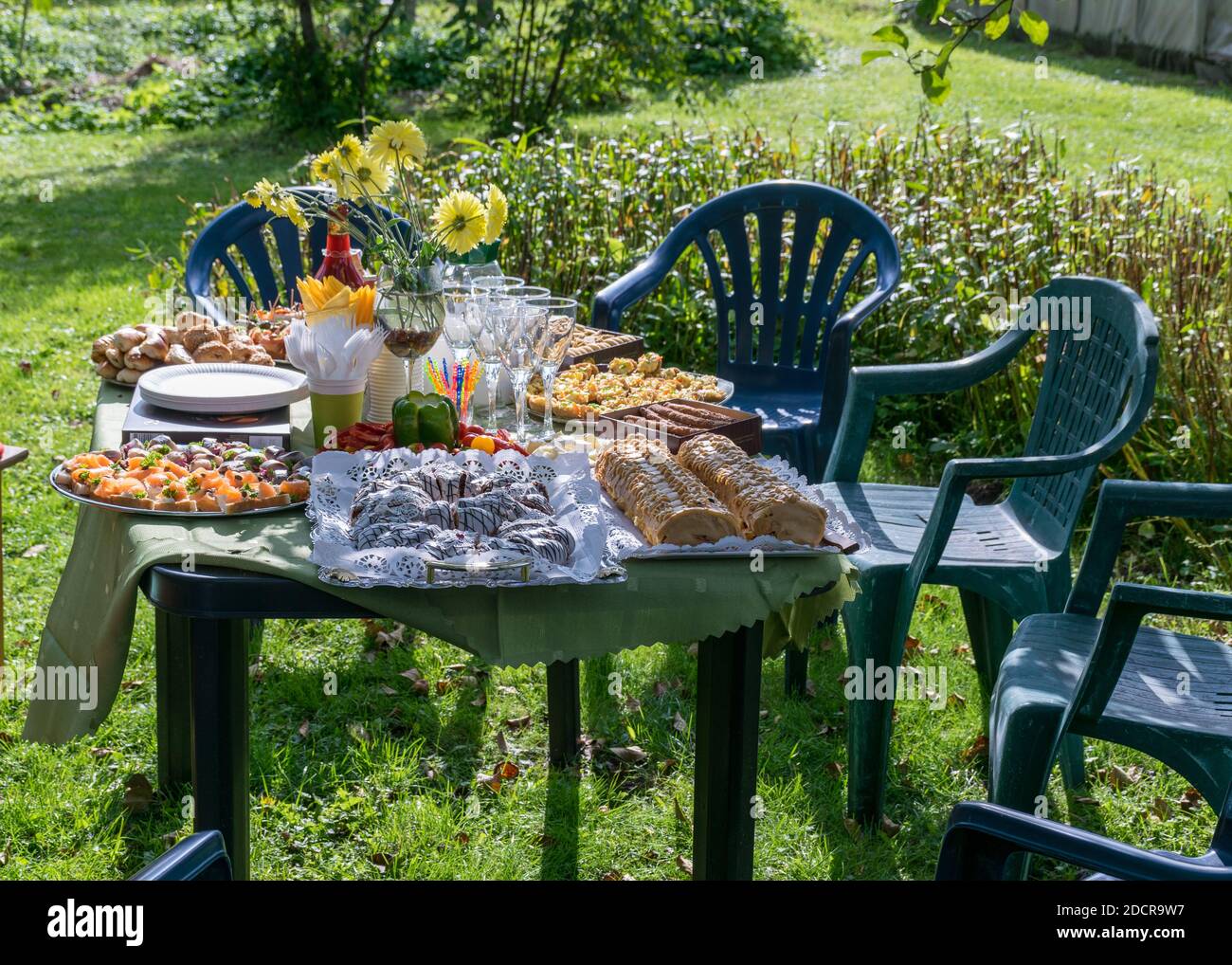 picture with a set table for the garden party, various dishes on the ...