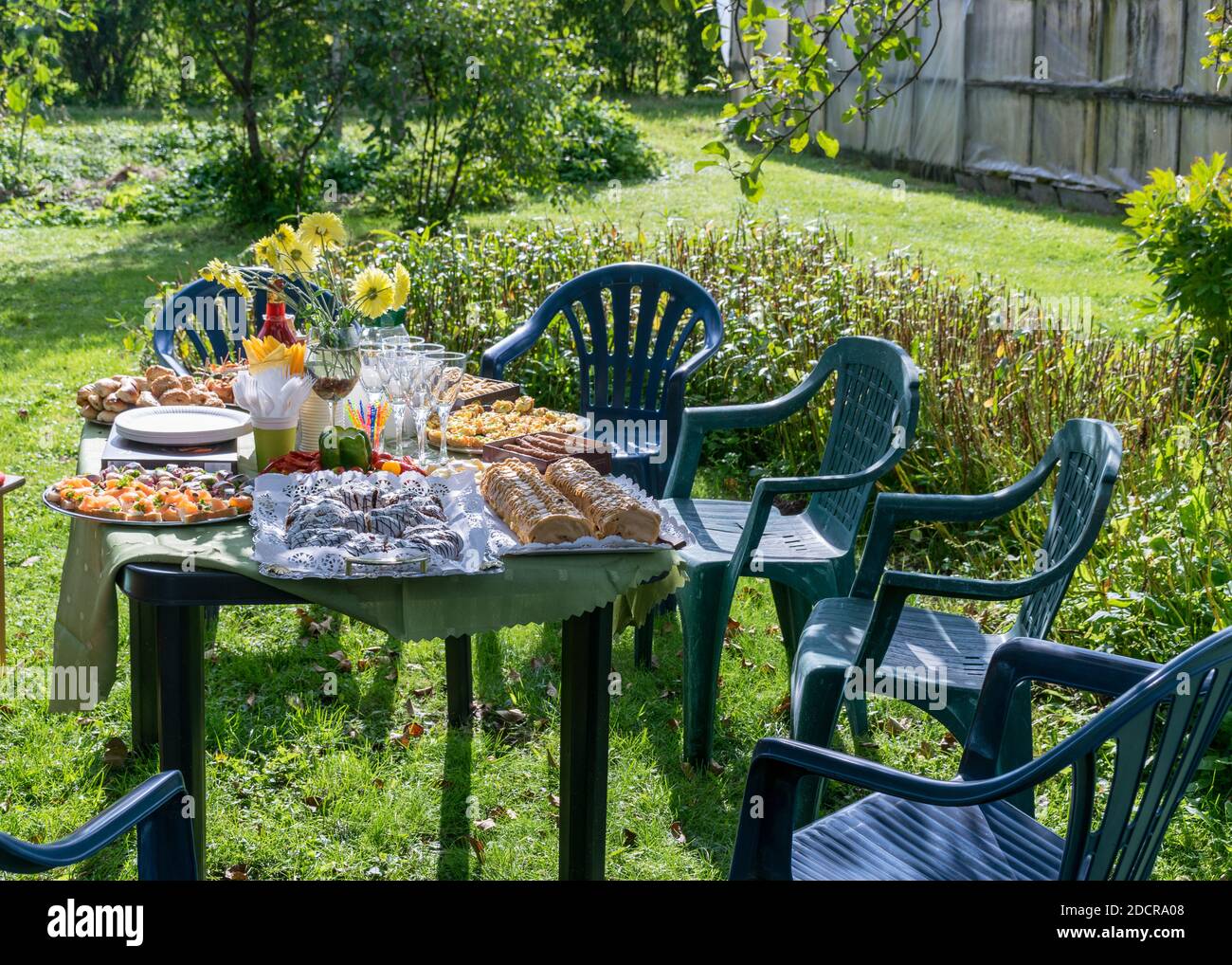 picture with a set table for the garden party, various dishes on the ...