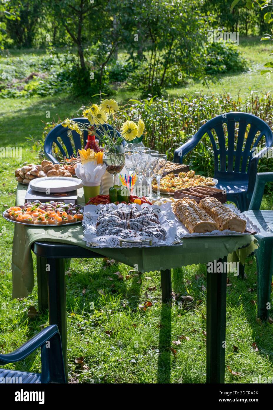 picture with a set table for the garden party, various dishes on the ...