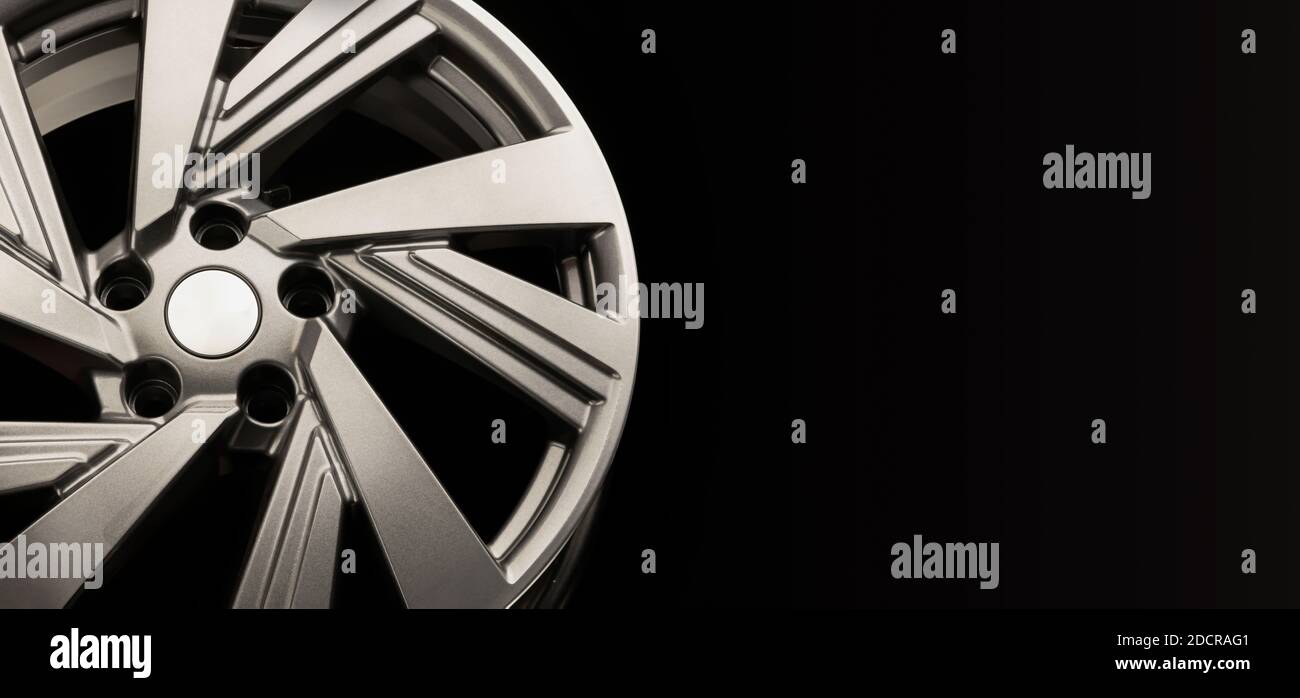 gray alloy wheel modern, close-up front view on a black background ...