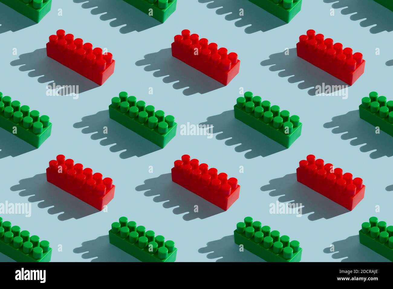 Red and green construction blocks on a blue background, seamless ...