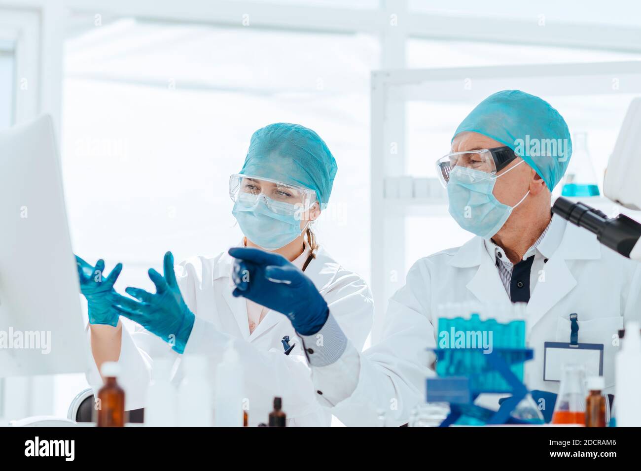group of scientists using a computer to classify data Stock Photo - Alamy