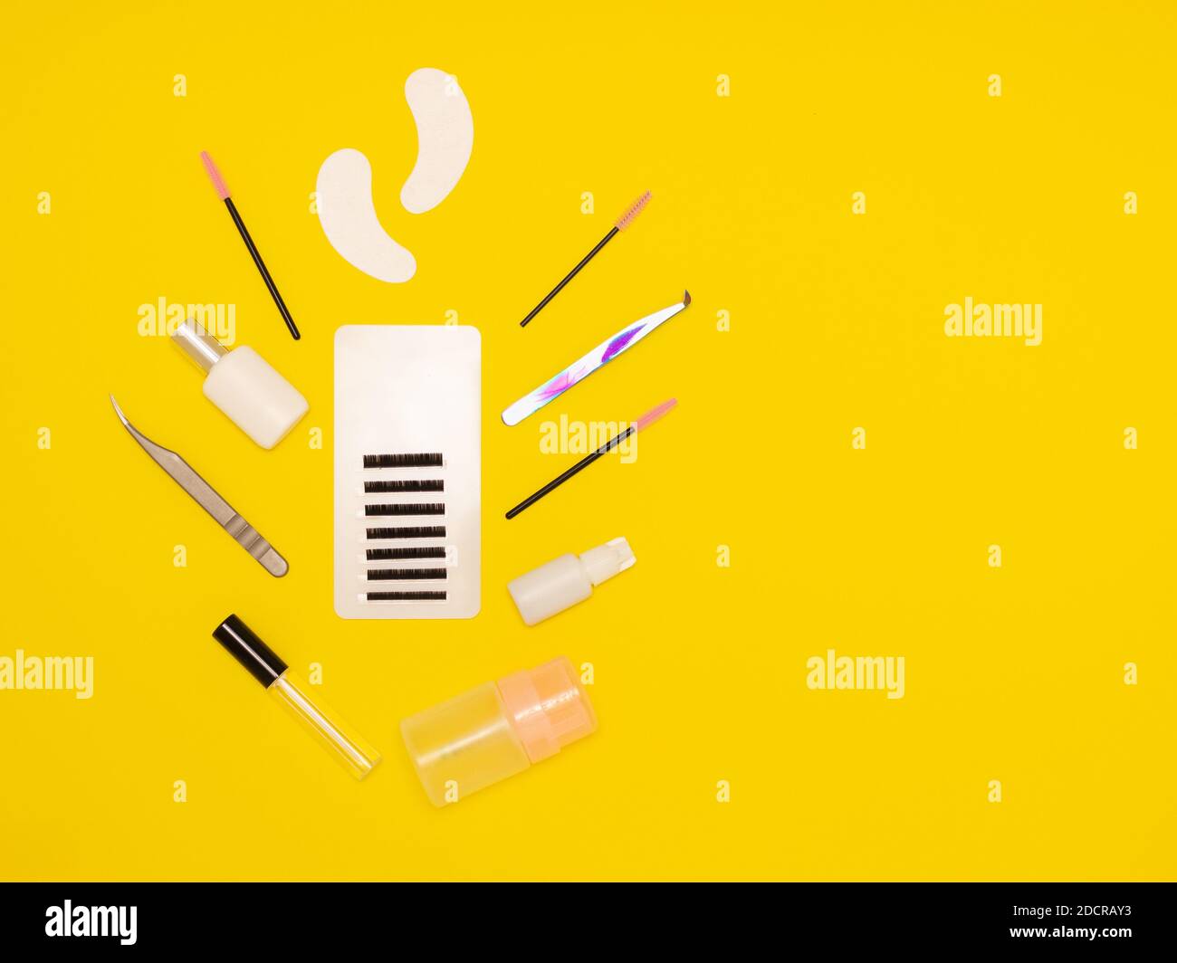 Tools for eyelash extension on a yellow background, top view. Eyelashes ...