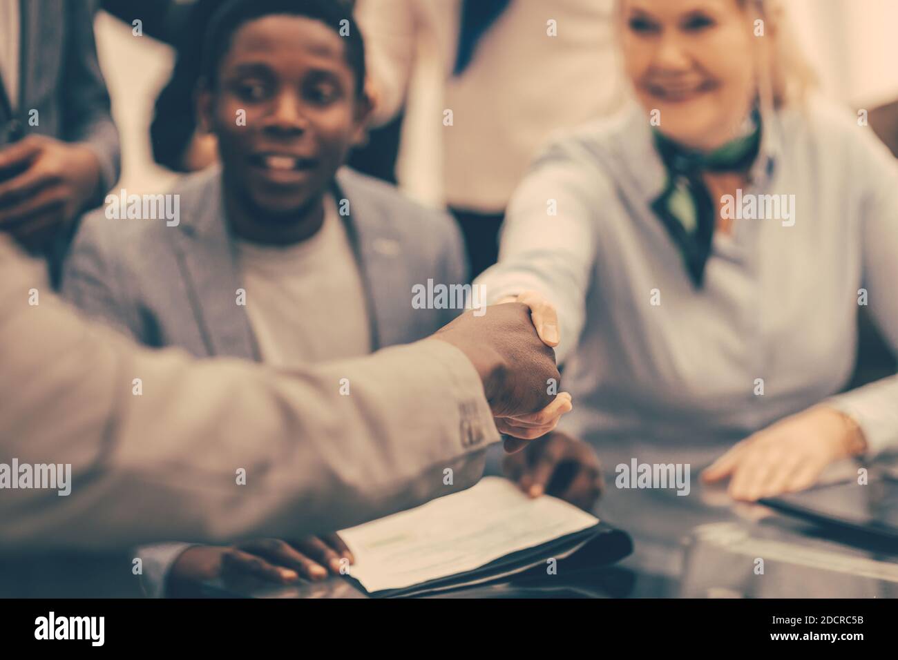 close up. smiling international business partners shaking hands Stock ...