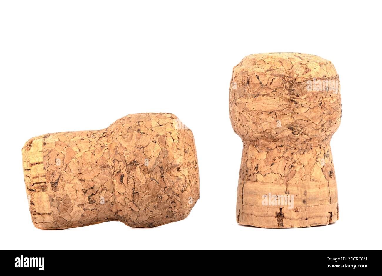Two corks of champagne close-up on a white background. One champagne ...