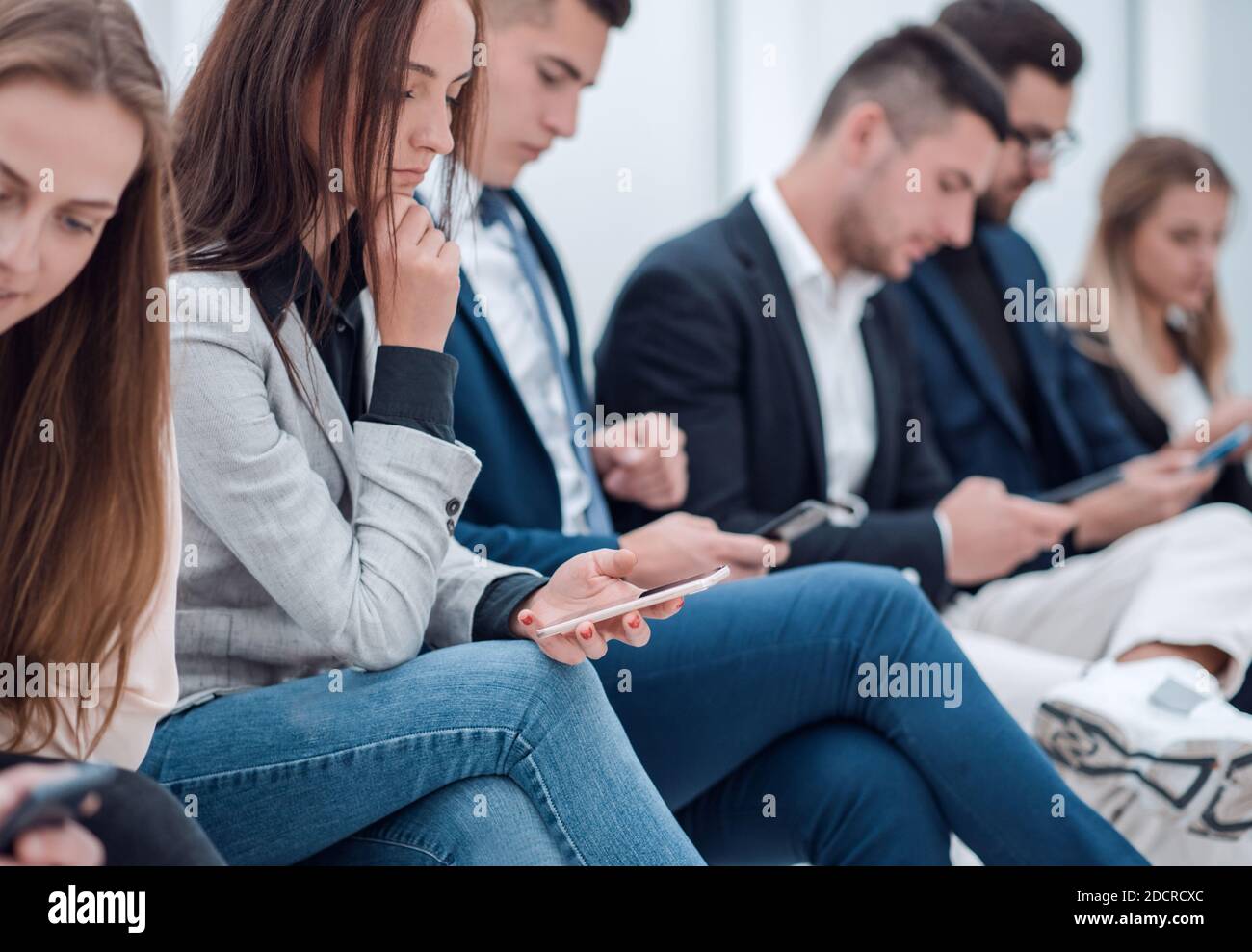 group of young people waiting, sitting in the queue Stock Photo - Alamy