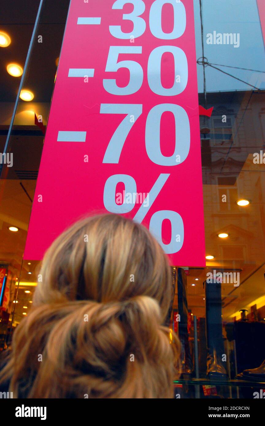 Sale sign in retail on shopping window, red background, white percent ...