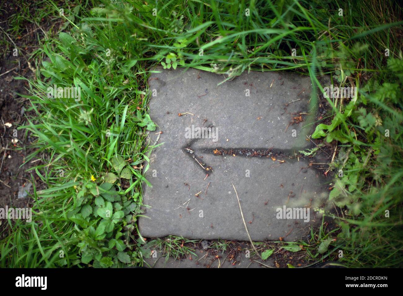 Carved direction arrow in paving stone, Newbrough, Northumberland Stock ...