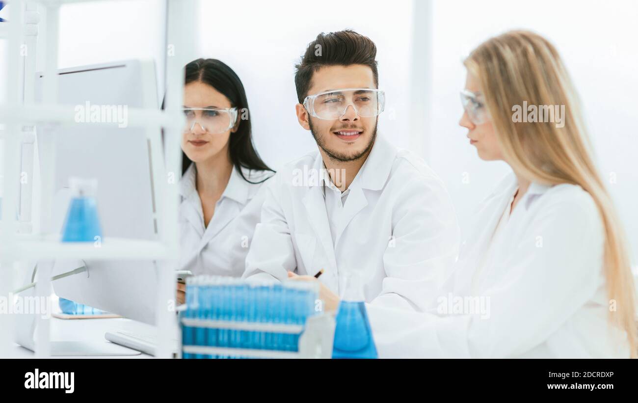 close up.a team of scientists sitting at the laboratory table Stock ...