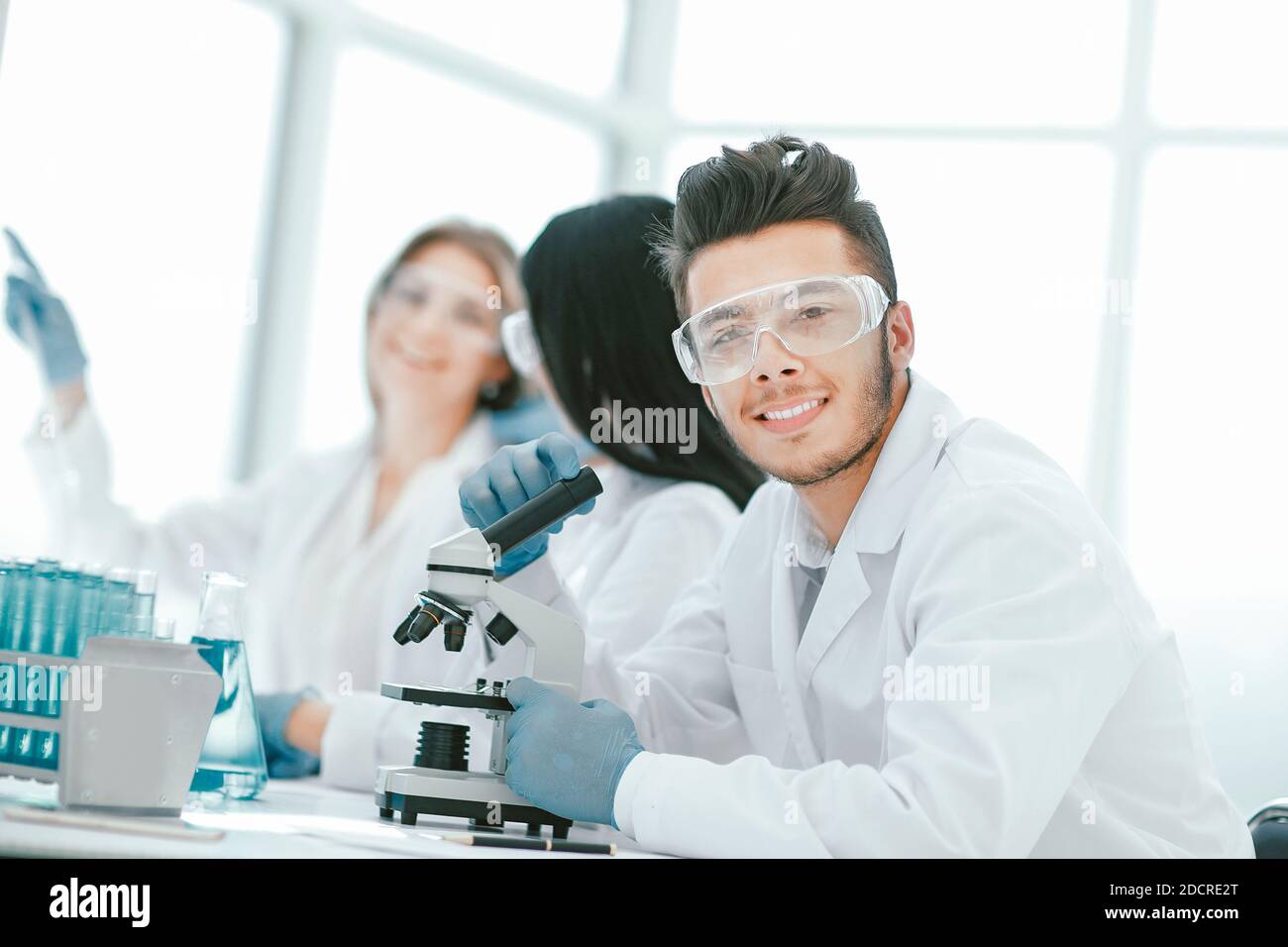 close up.male scientist sitting at a lab table Stock Photo - Alamy