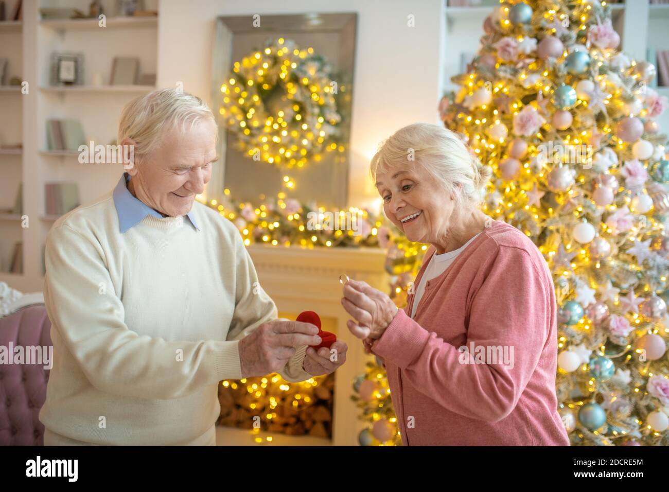 Elderly man making a proposal to a surprised woman Stock Photo - Alamy