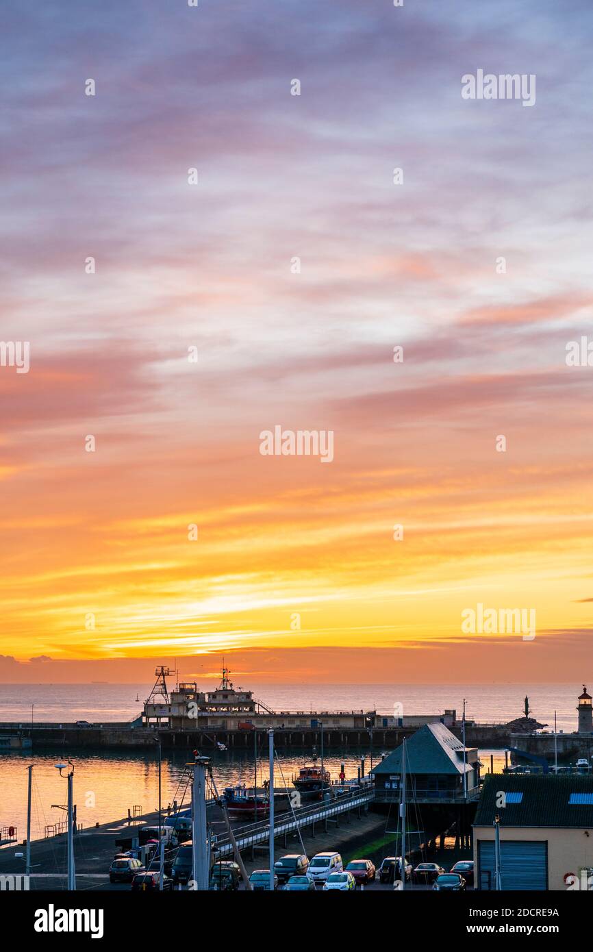 Daybreak and the dawn cloudy sky lit up by the sun still below the ...