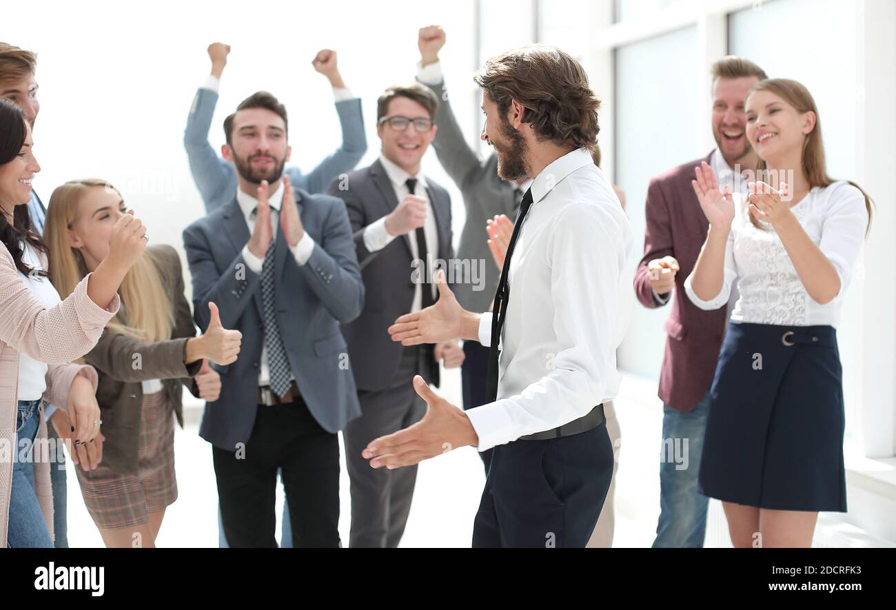 happy young businessman standing in front of his business team Stock ...