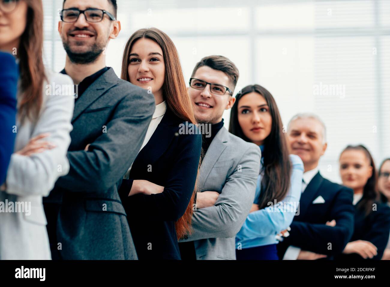 close up. a group of diverse smiling business people standing in a row ...