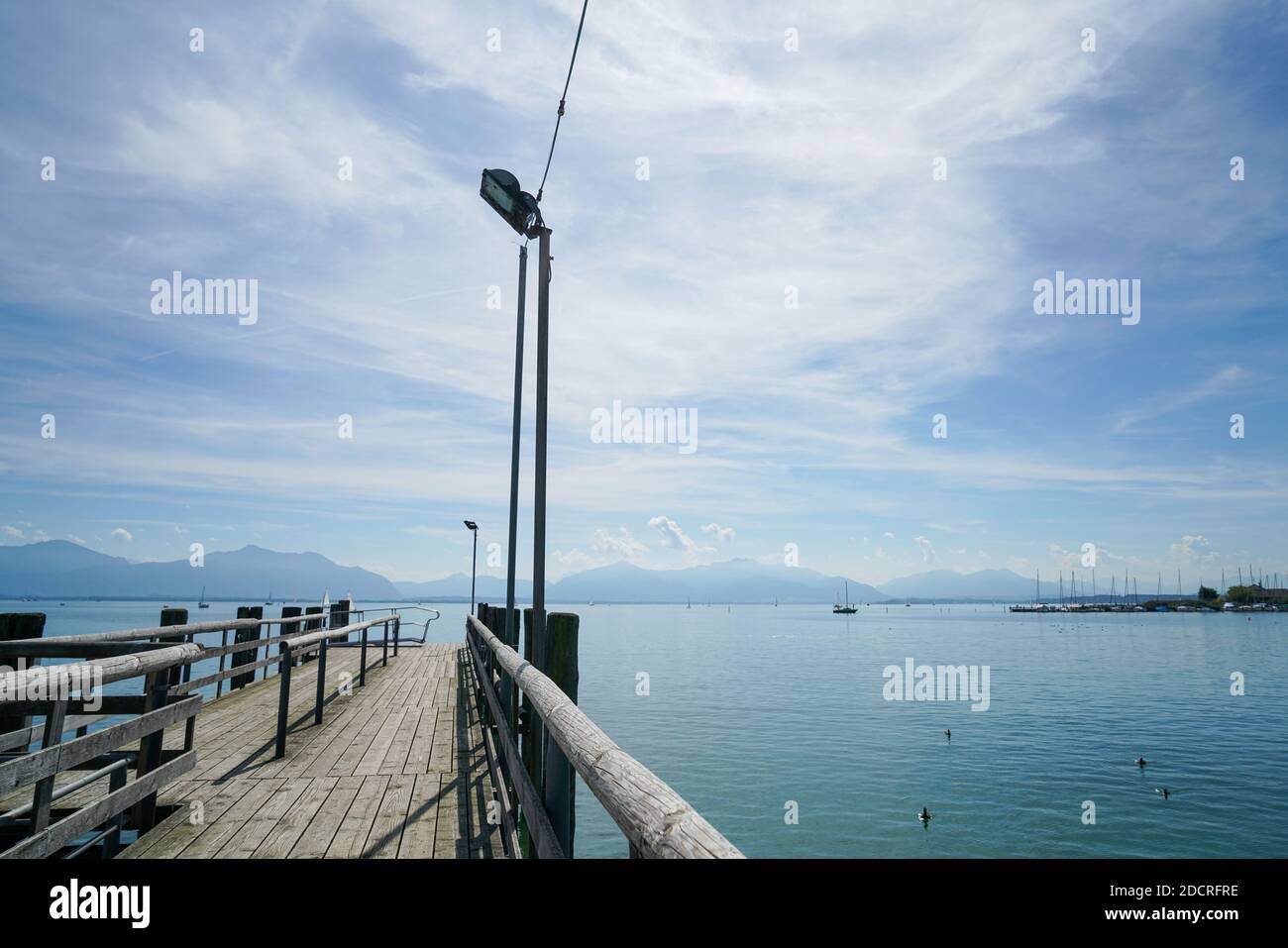 A beautiful cloudscape over a pier wooden dock and a calm seascape view ...