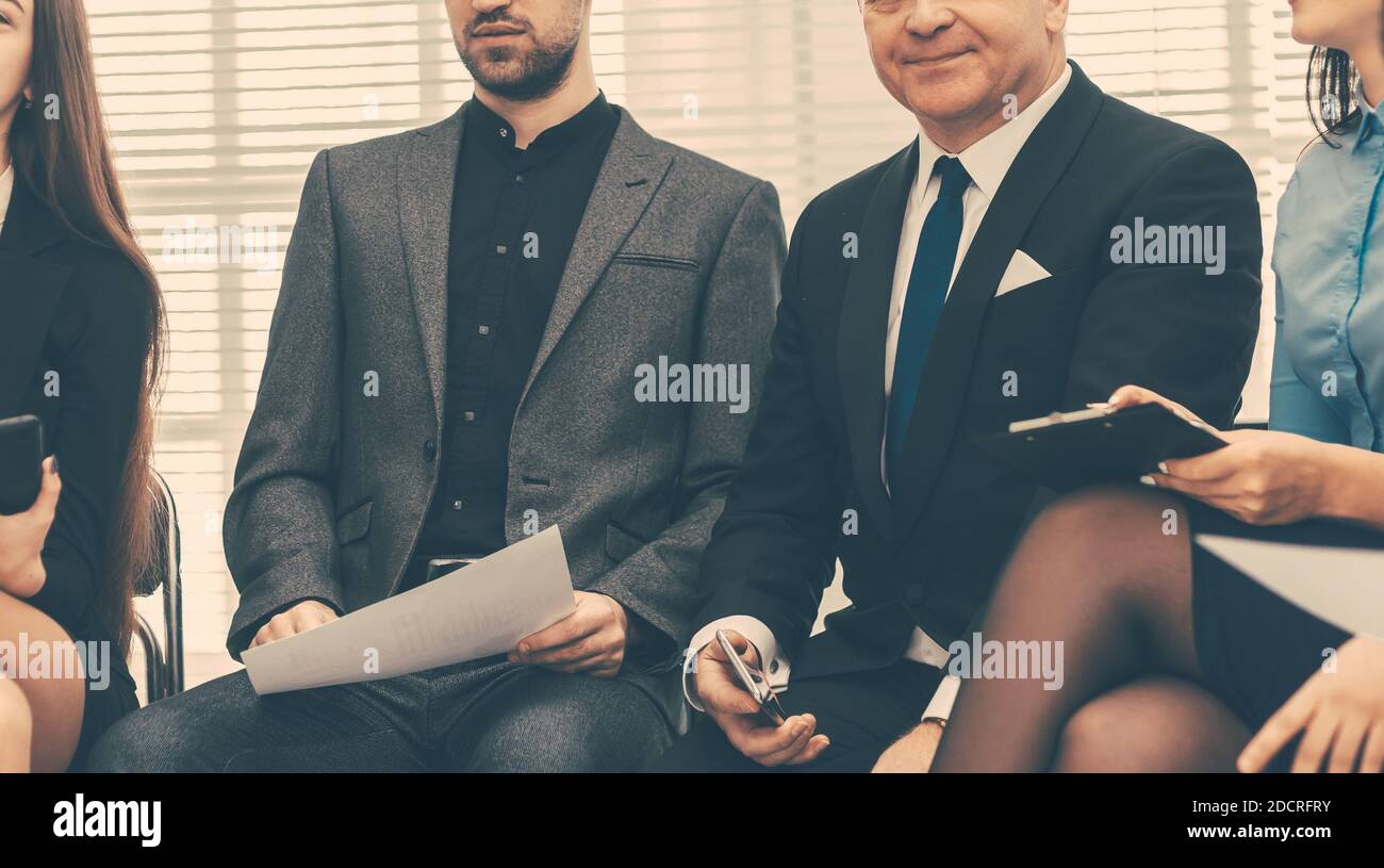 close up. employees asking questions at a work meeting Stock Photo - Alamy