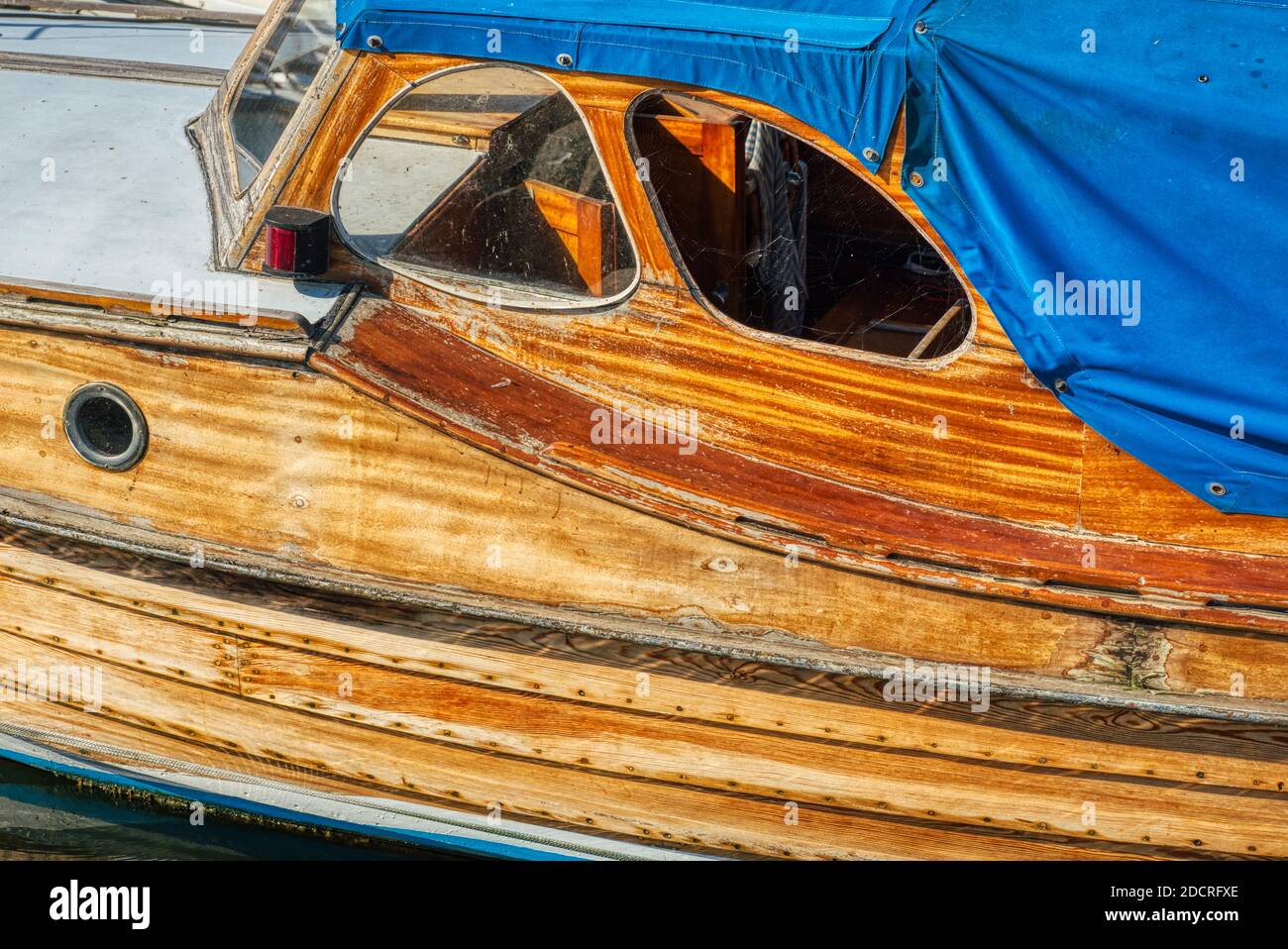 Old, wooden sailing boat cockpit closeup. The vessel windows are ...