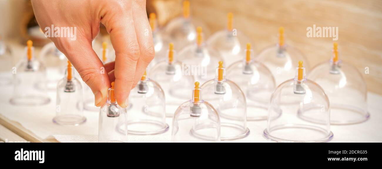 Masseur takes vacuum massage glass jars of traditional Chinese cupping ...