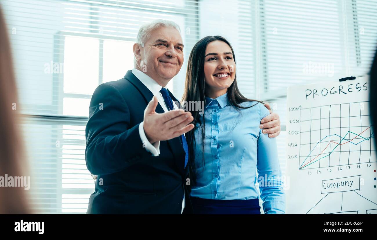 boss and young speaker standing together in front of business ...
