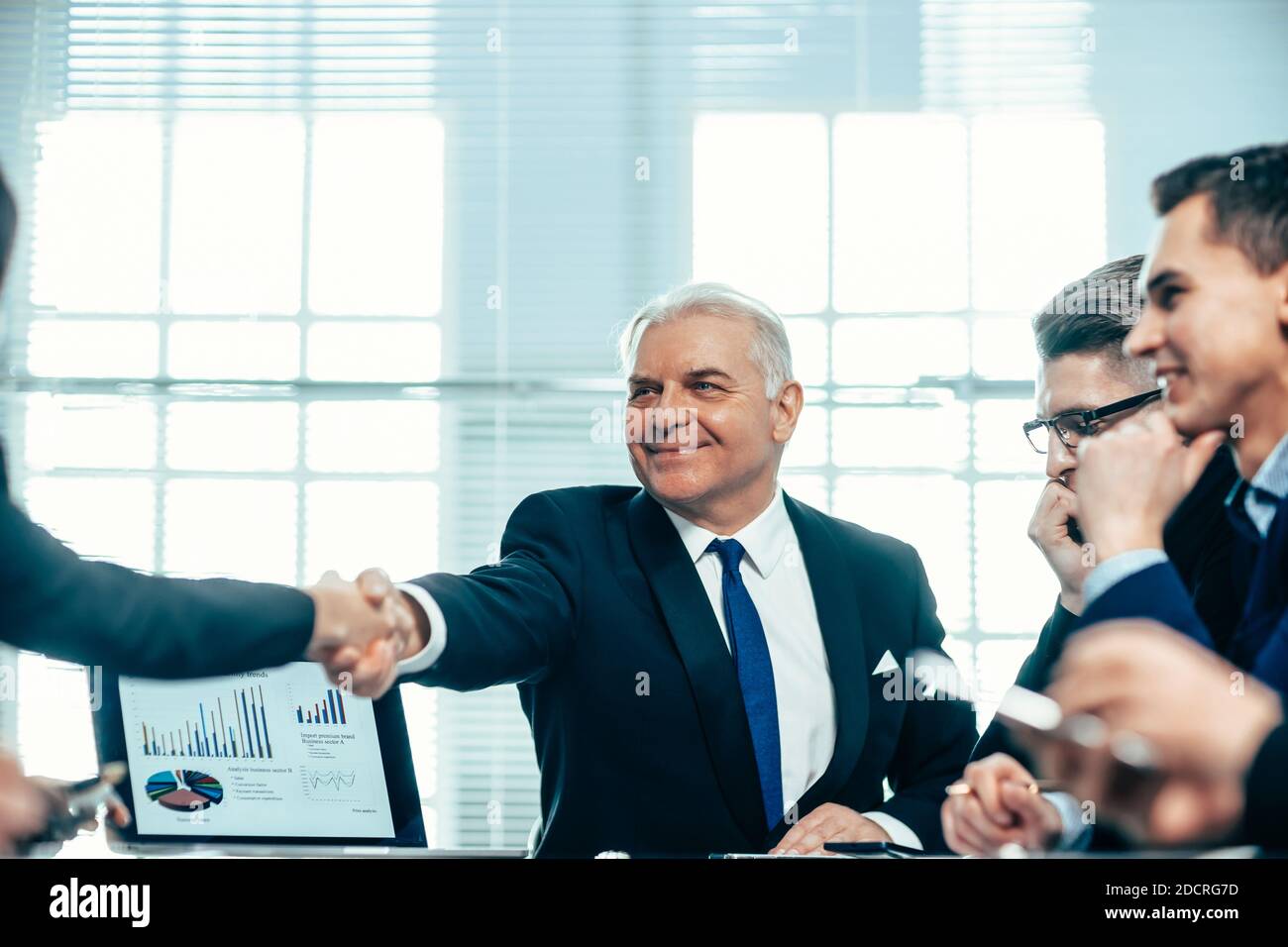 financial partners confirm their success with a handshake Stock Photo ...