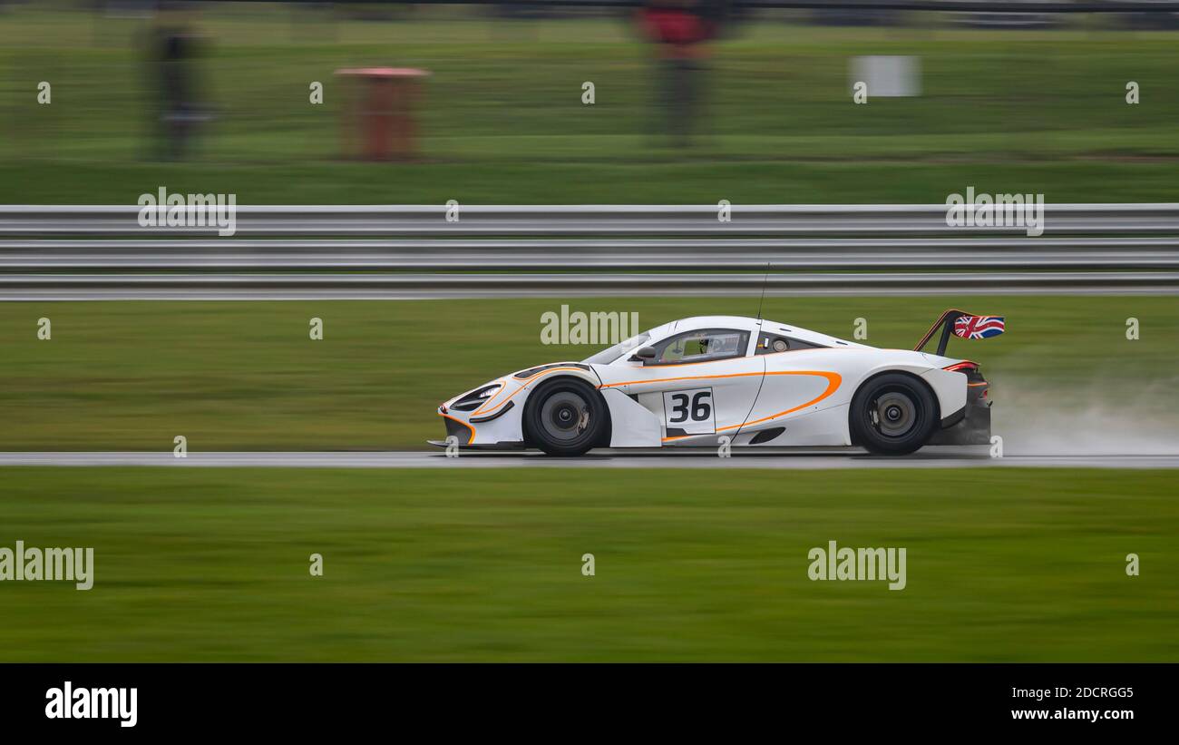 A panning shot of a racing car as it circuits a track Stock Photo - Alamy