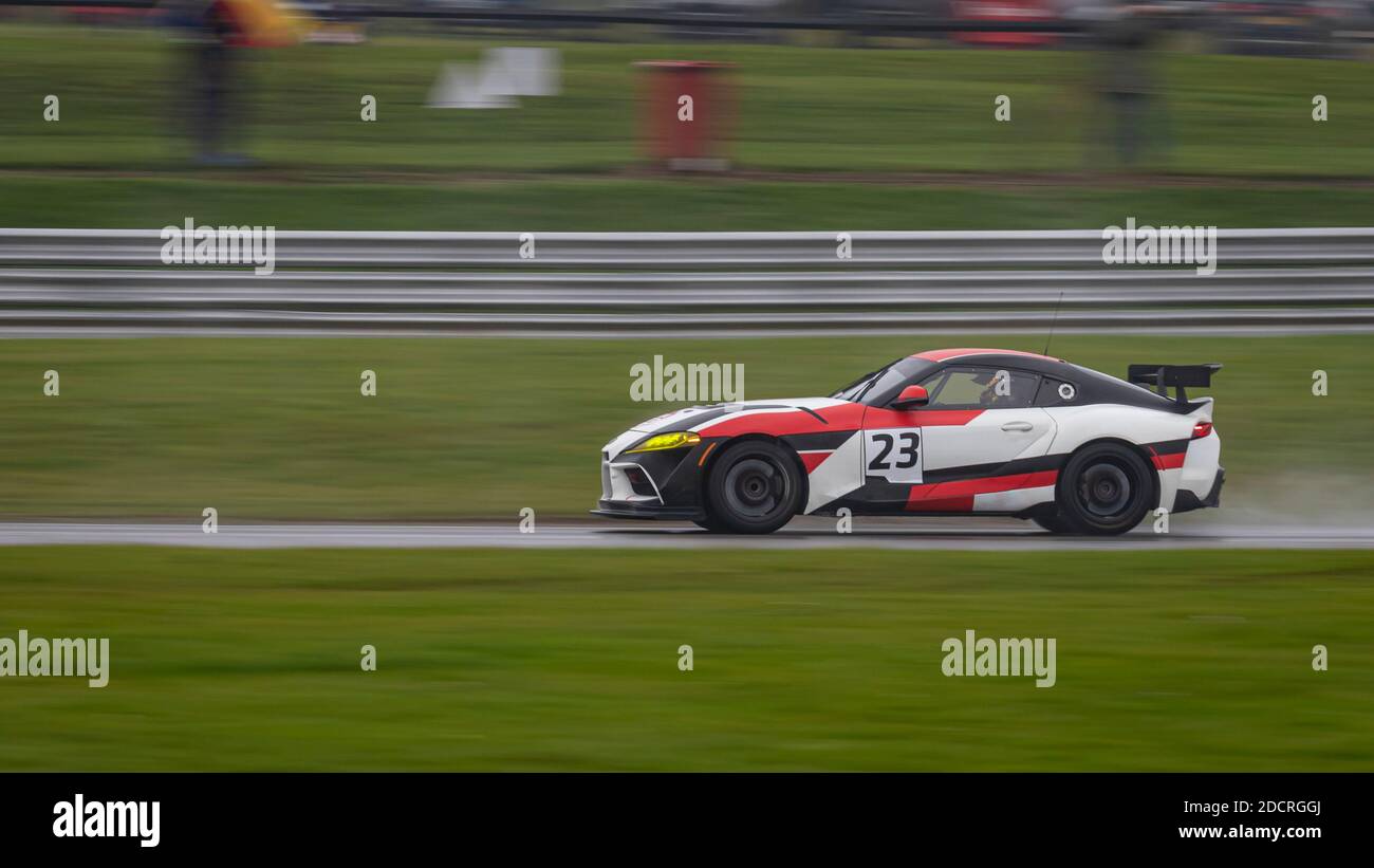A panning shot of a racing car as it circuits a track Stock Photo - Alamy